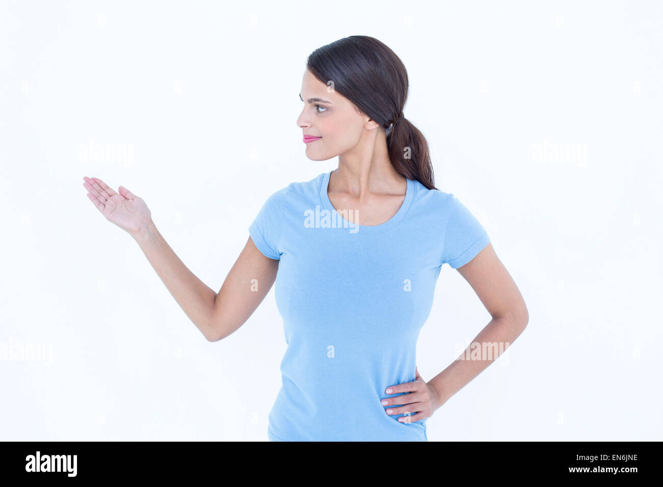 Woman smiling presenting something with her hand Stock Photo - Alamy