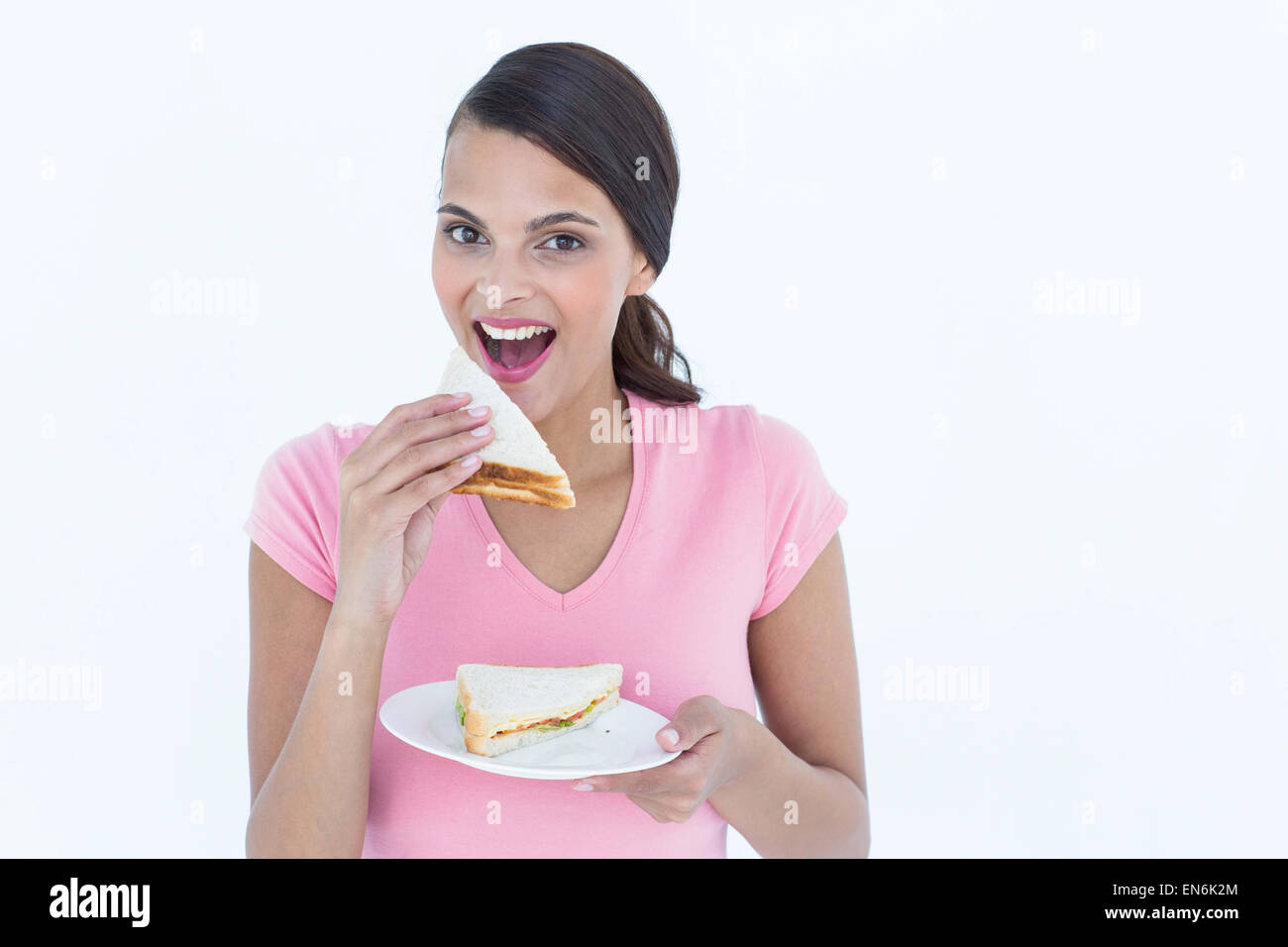 Beautiful woman eating sandwich Stock Photo - Alamy