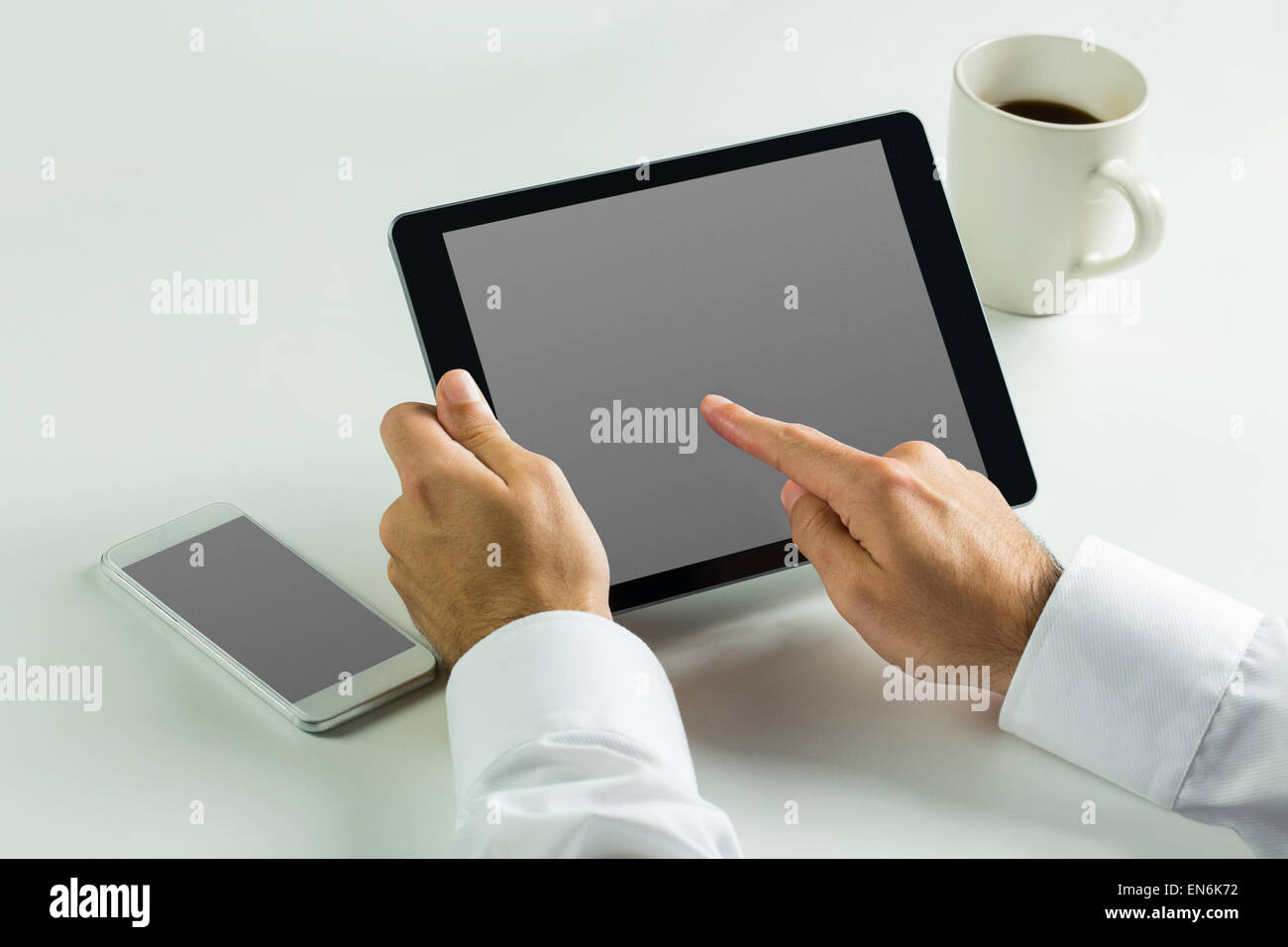 Businessman using his tablet pc Stock Photo - Alamy