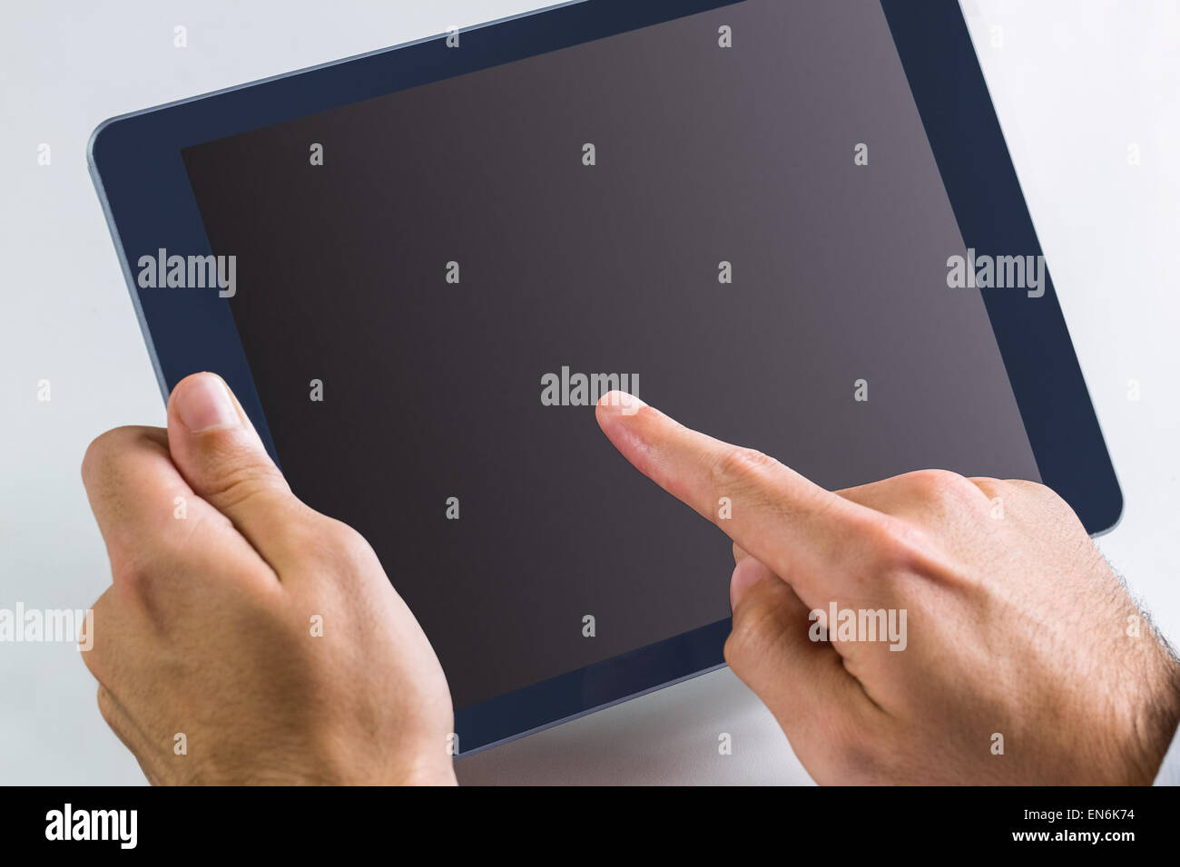 Businessman using his tablet pc Stock Photo - Alamy