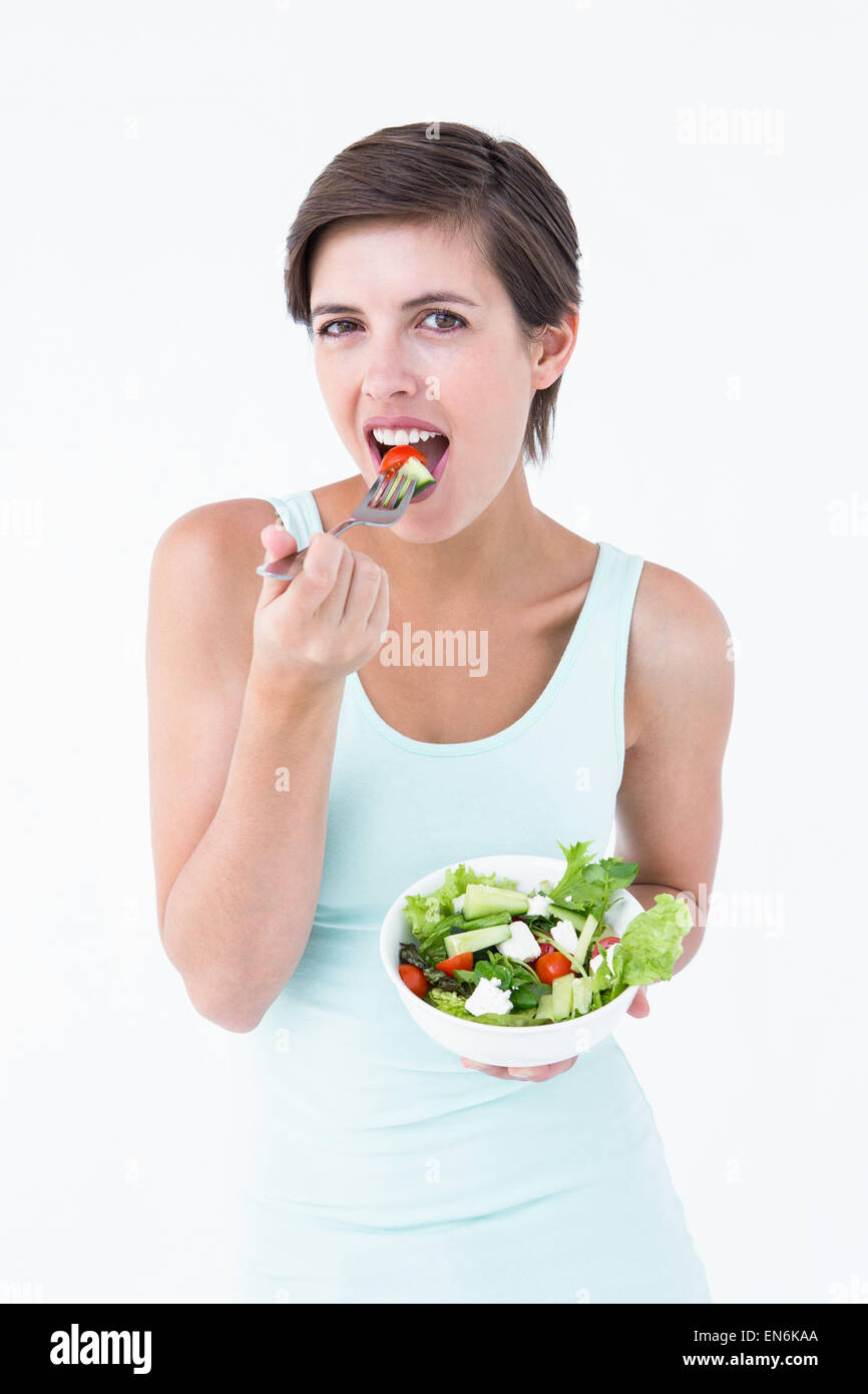 Pretty woman eating bowl of salad Stock Photo - Alamy