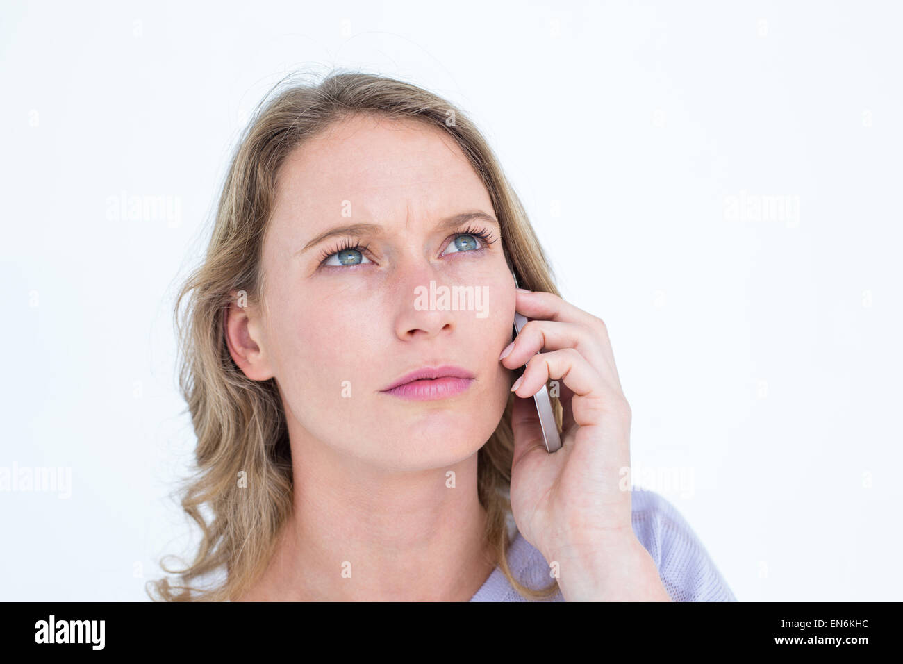 Unsmiling woman calling with her smartphone Stock Photo - Alamy