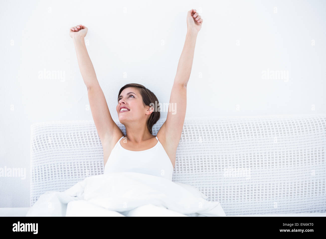 Happy woman waking up Stock Photo - Alamy