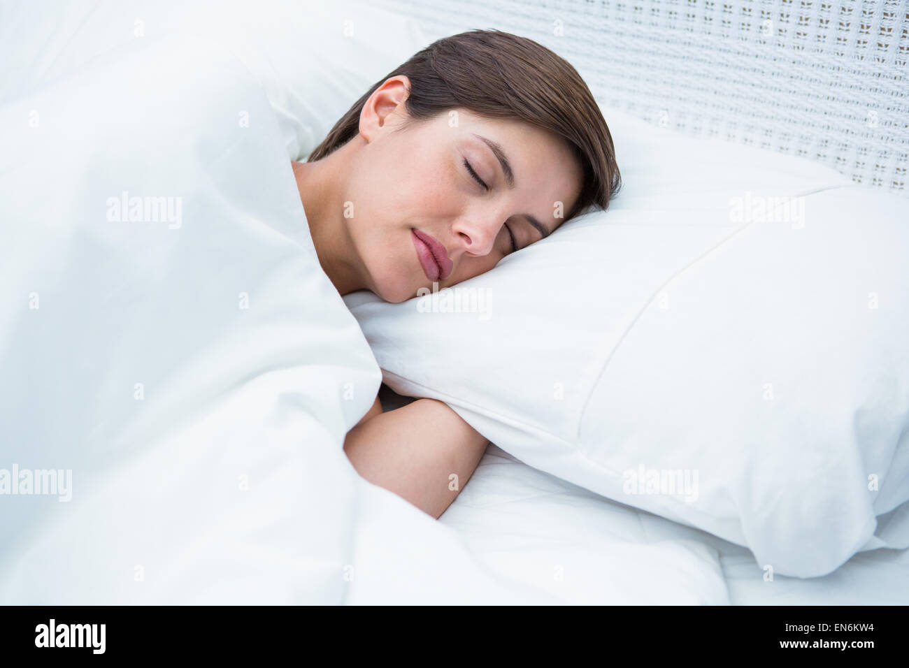 Peaceful brunette sleeping Stock Photo - Alamy