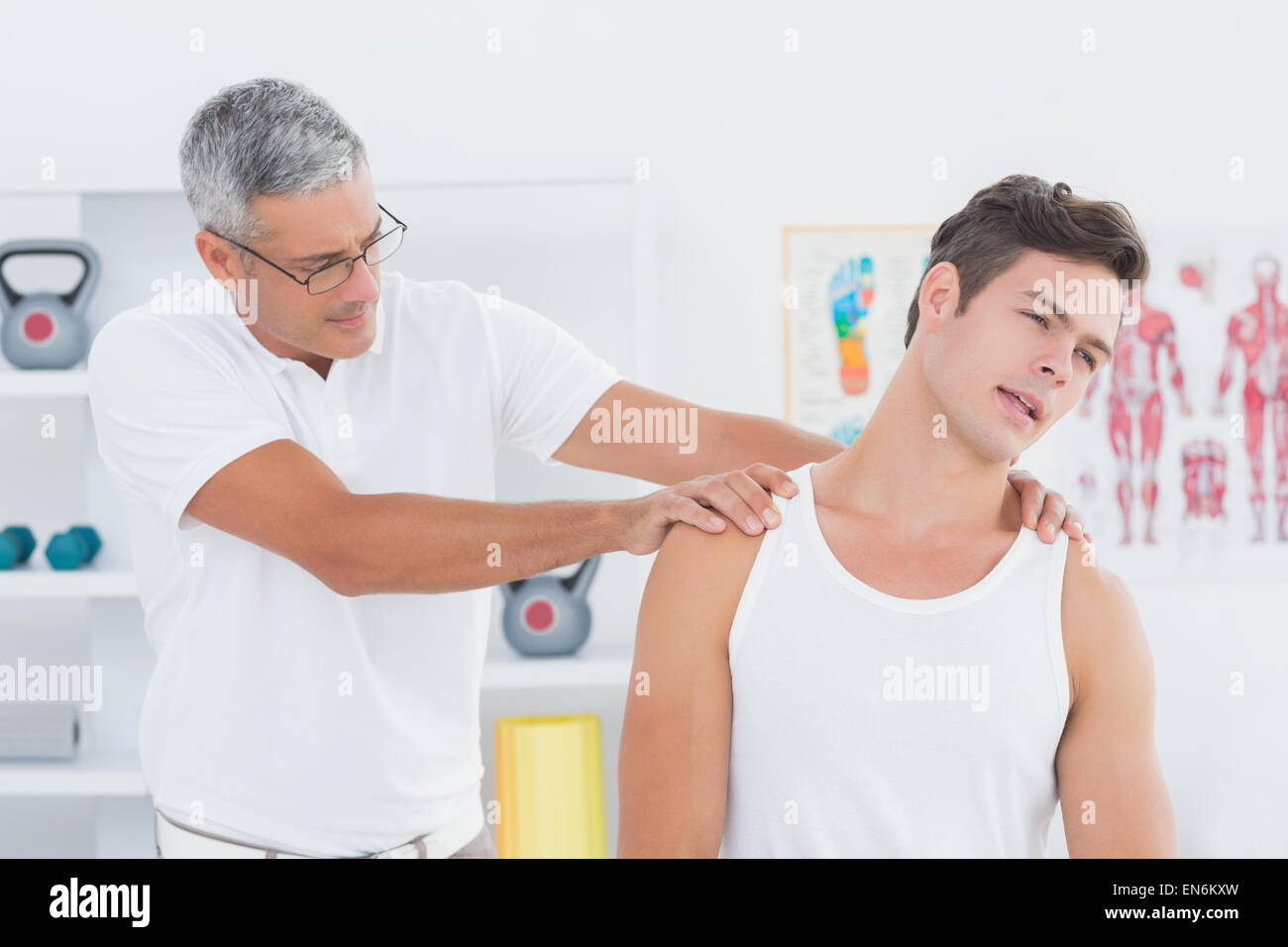 Doctor examining his patient neck Stock Photo - Alamy