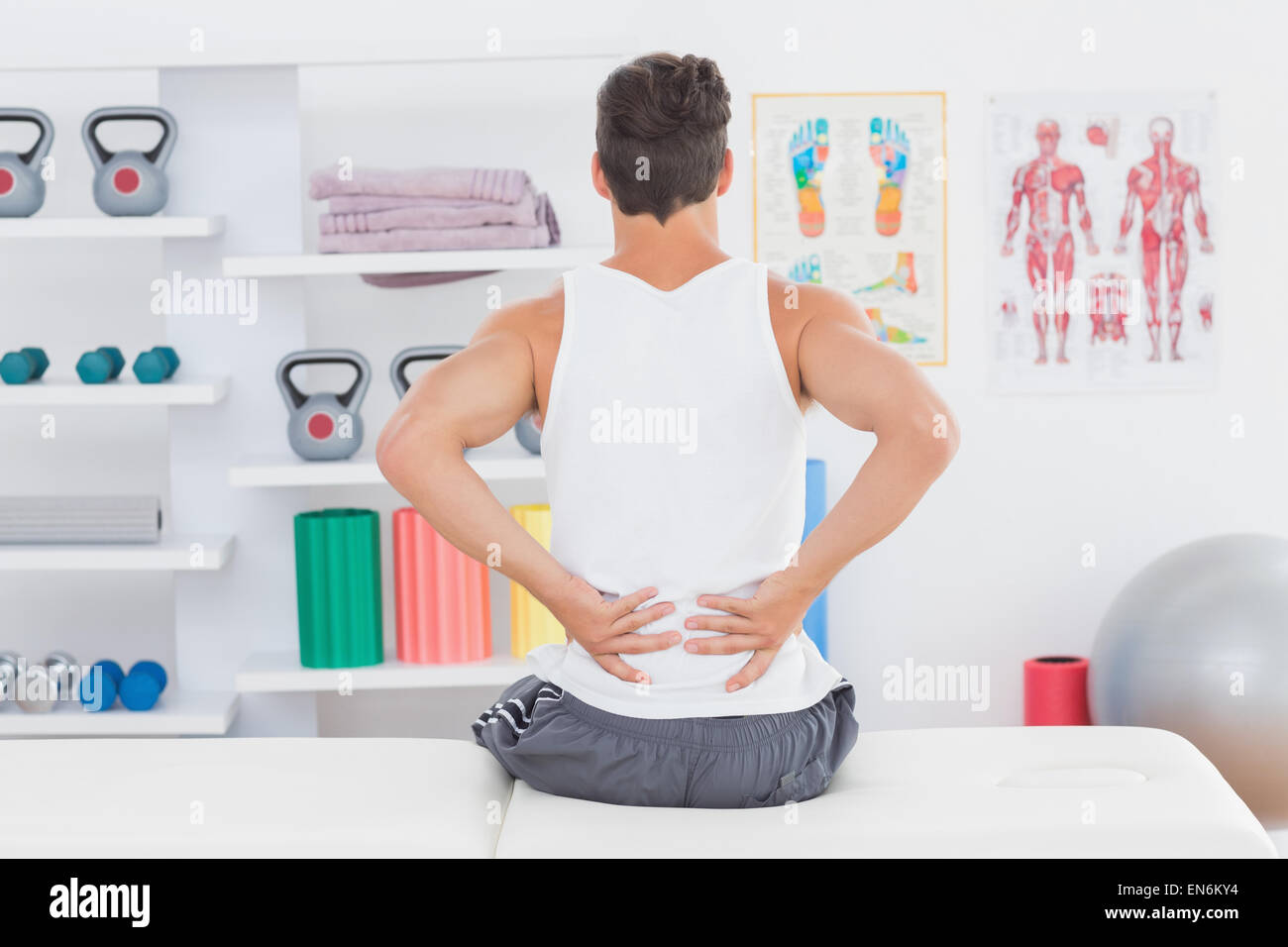 Young man suffering from back pain Stock Photo - Alamy
