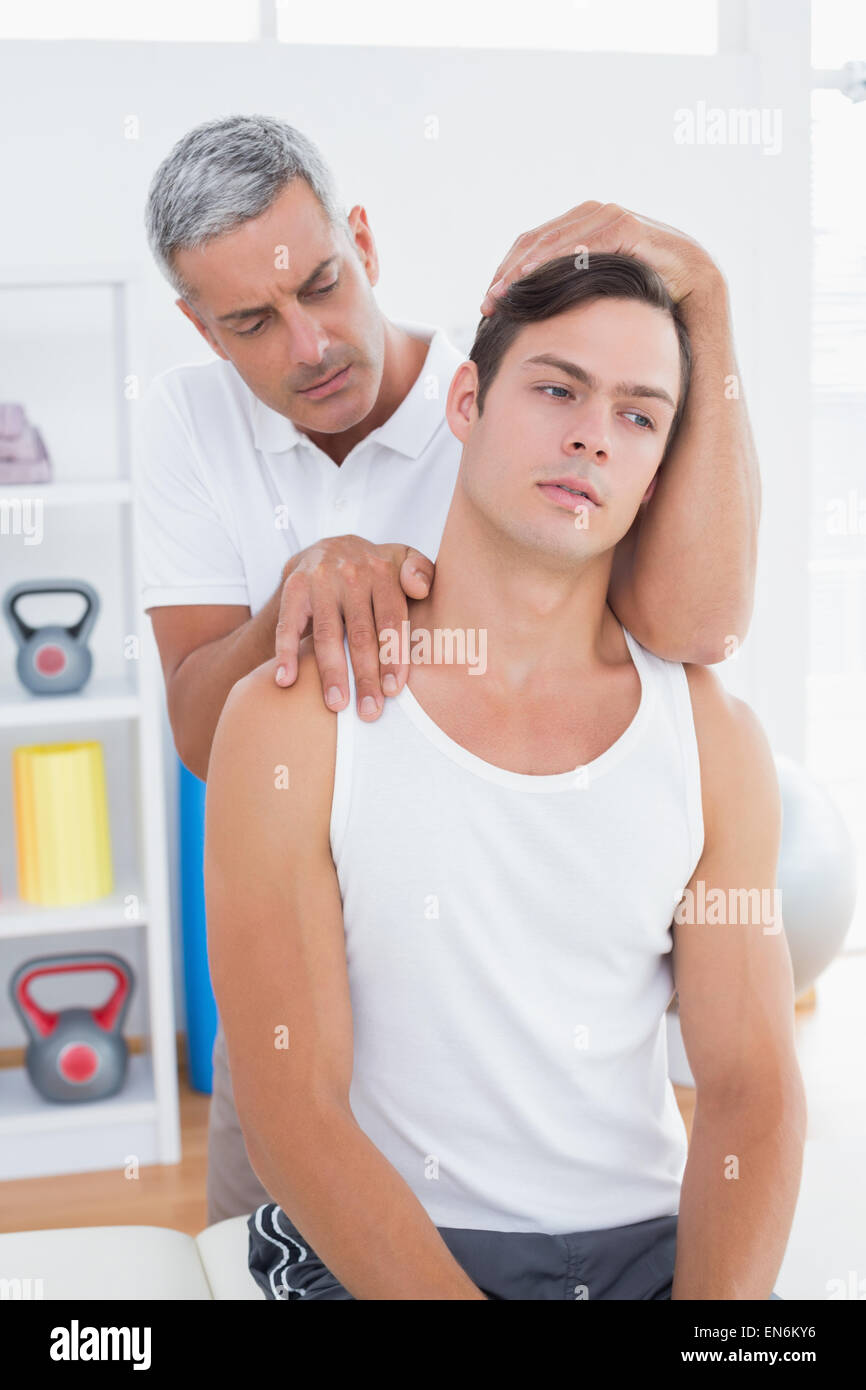 Doctor doing neck adjustment Stock Photo - Alamy