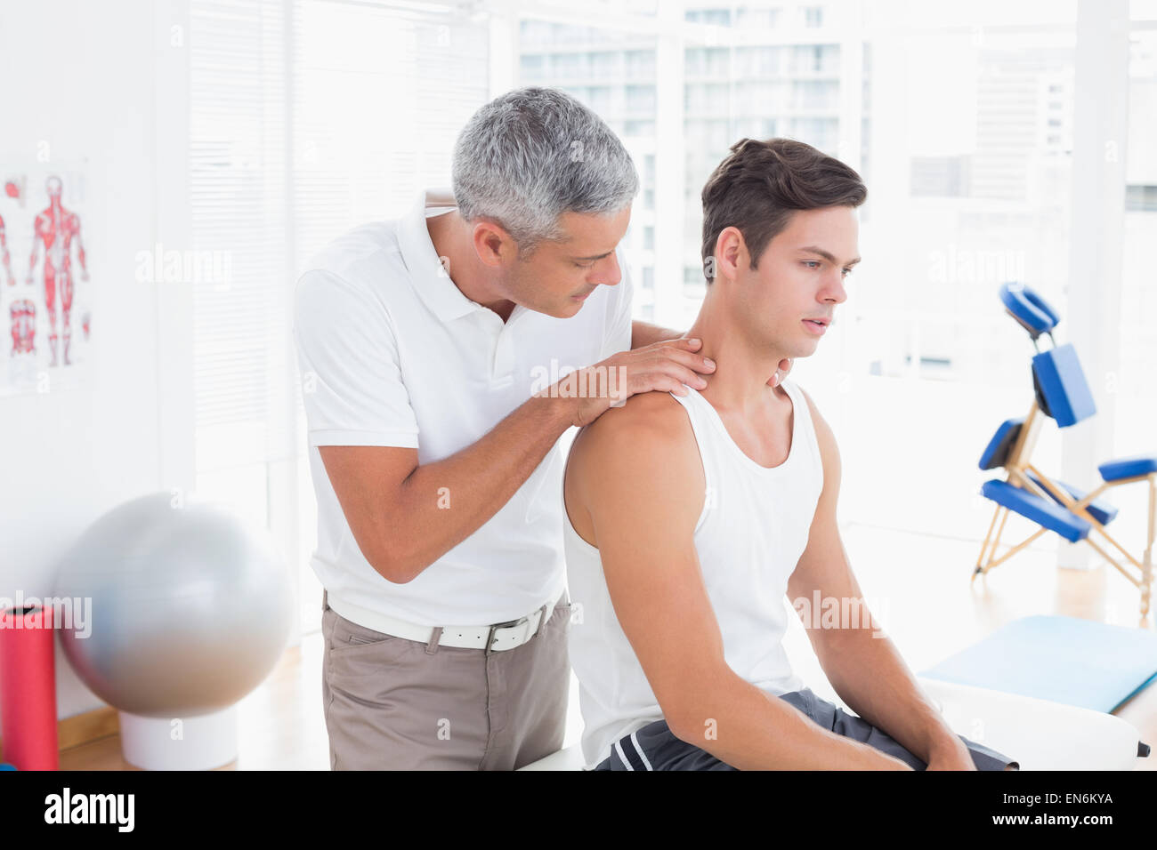 Doctor examining his patient neck Stock Photo - Alamy