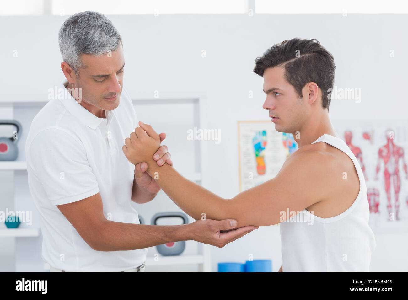 Doctor holding arm hi-res stock photography and images - Alamy