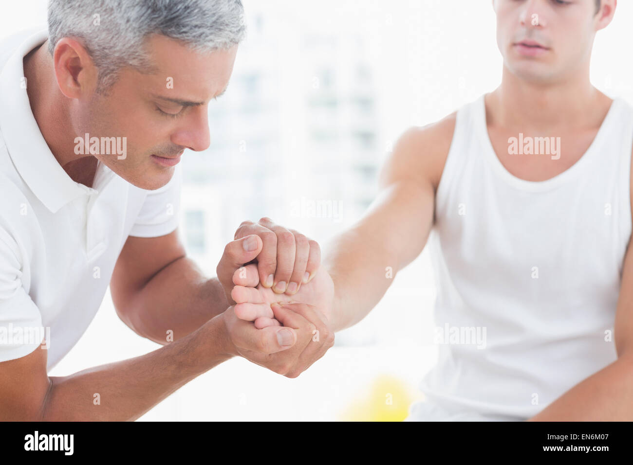 Doctor examining his patient hand Stock Photo - Alamy