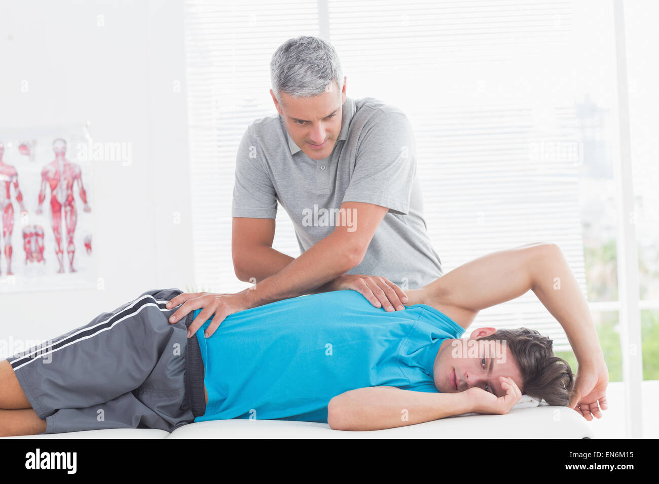 Doctor examining his patient back Stock Photo - Alamy