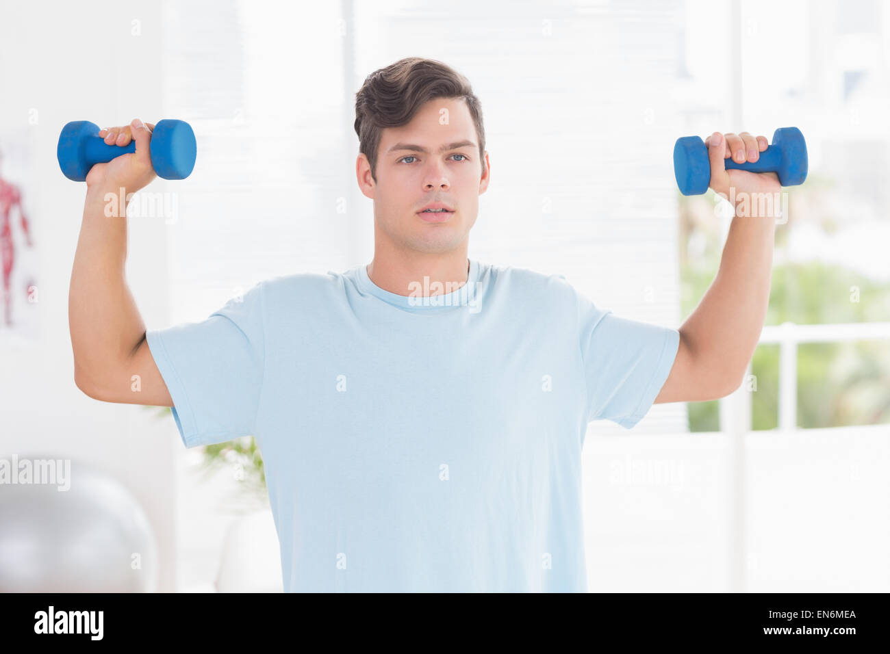 Strong man training dumbbells hi-res stock photography and images - Alamy