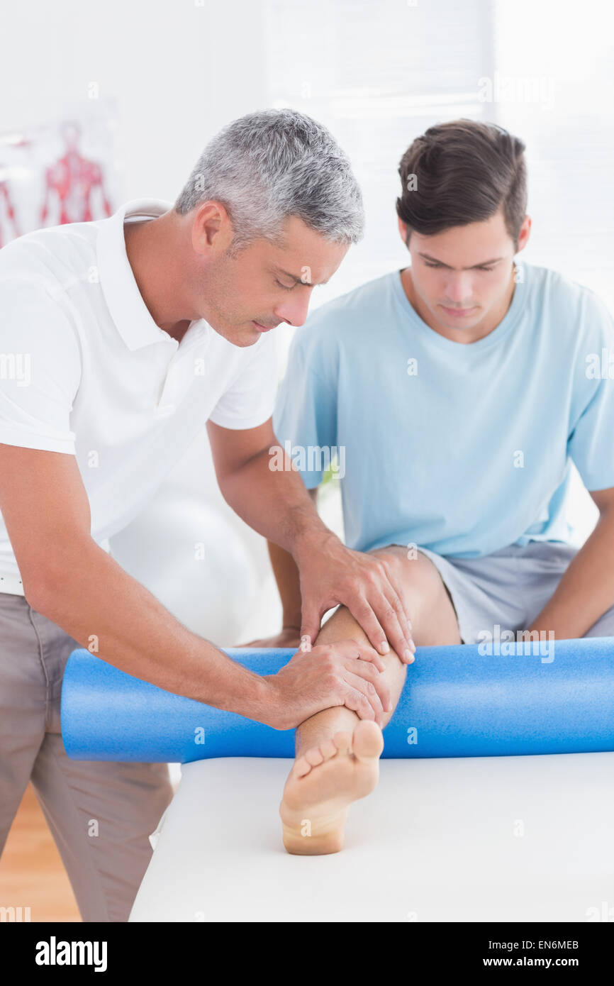Doctor examining his patient leg Stock Photo - Alamy