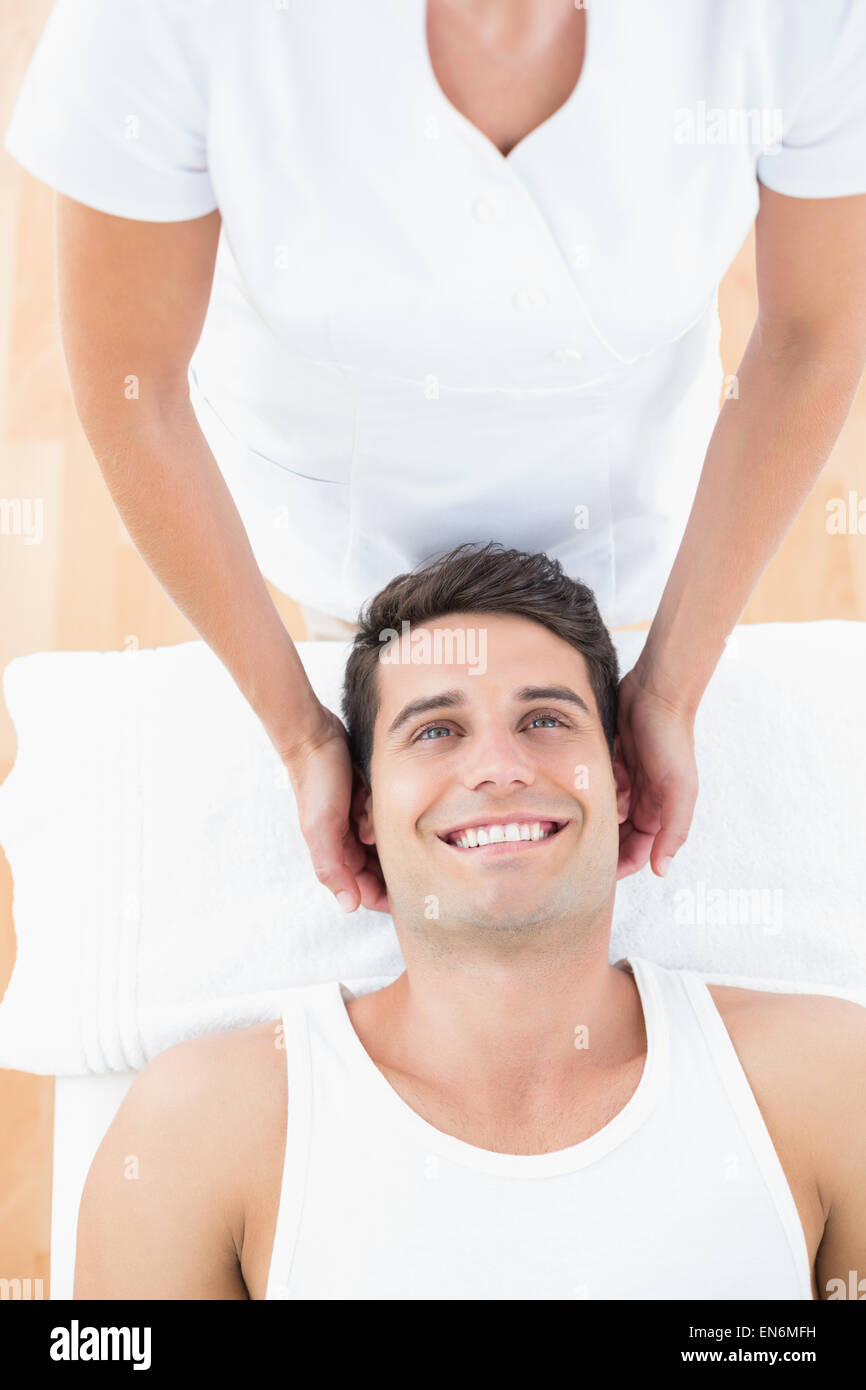 Smiling man receiving neck massage Stock Photo - Alamy