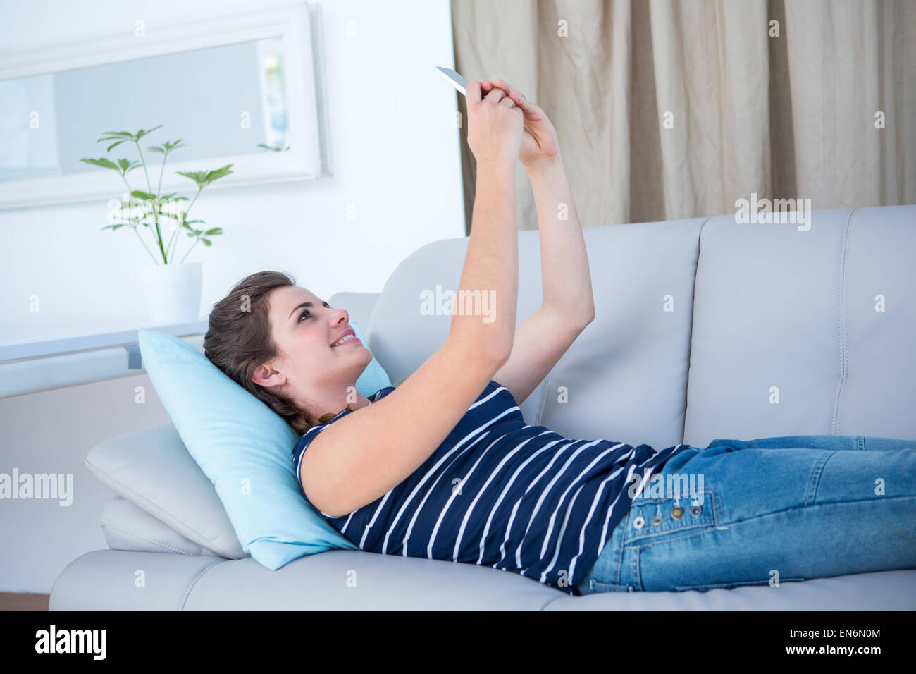 Woman taking selfie lying on hi-res stock photography and images - Alamy