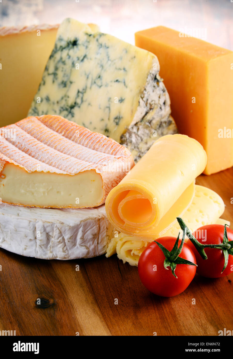 Different sorts of cheese isolated on kitchen table Stock Photo - Alamy