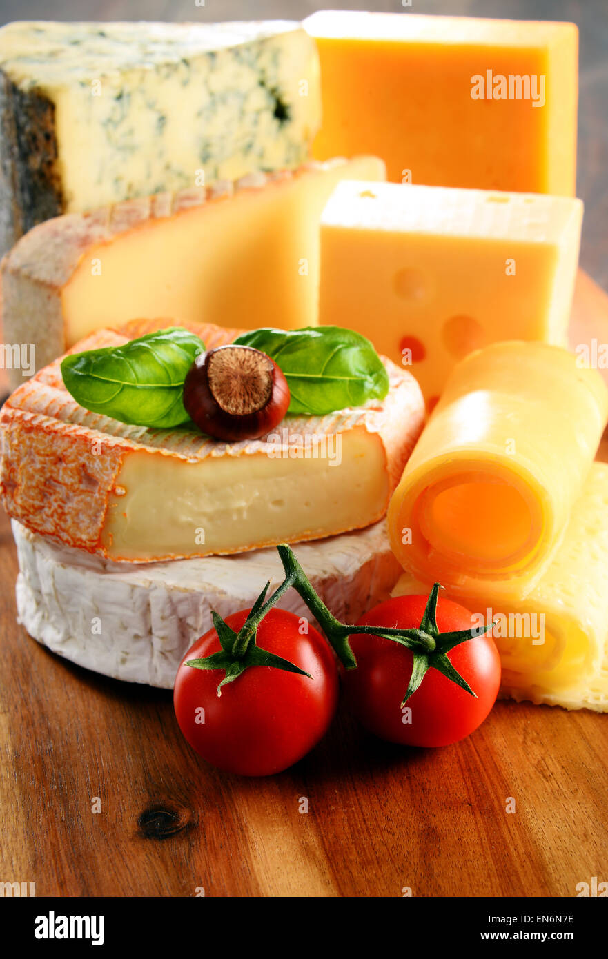 Different sorts of cheese isolated on kitchen table Stock Photo - Alamy