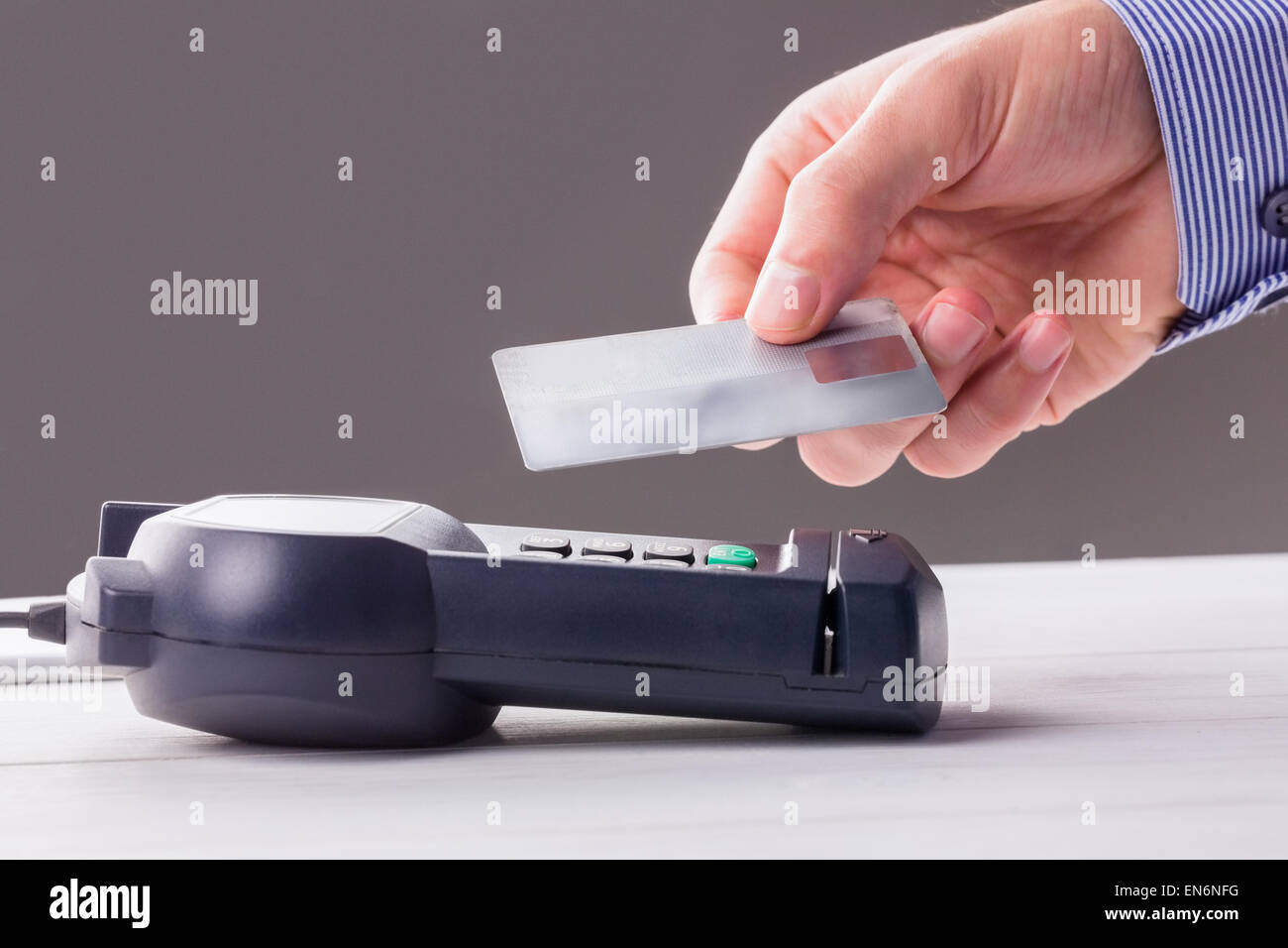 Man using card to express pay Stock Photo - Alamy