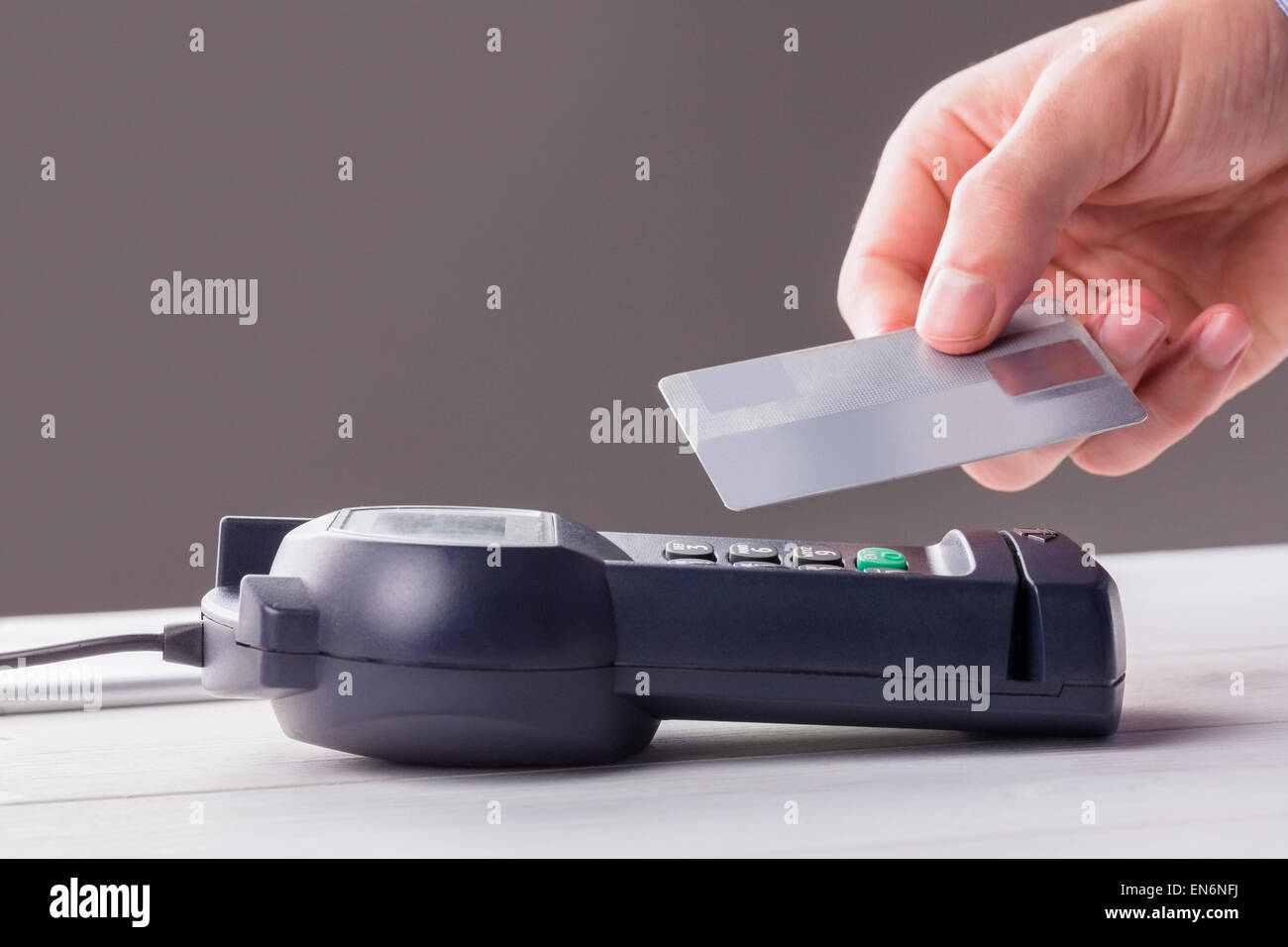 Man using card to express pay Stock Photo - Alamy