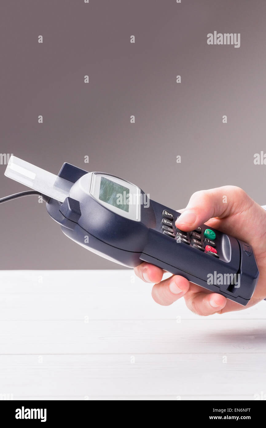 Man entering his pin on terminal Stock Photo - Alamy