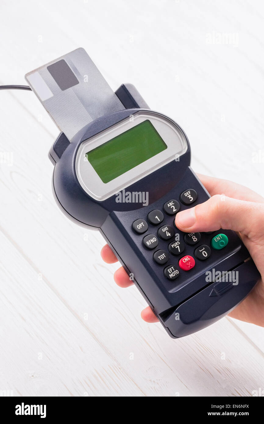 Man entering his pin on terminal Stock Photo - Alamy