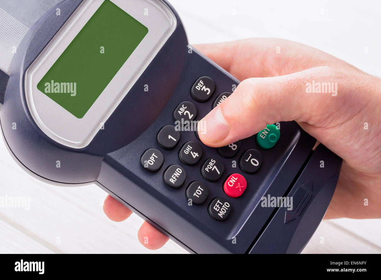 Man entering his pin on terminal Stock Photo - Alamy