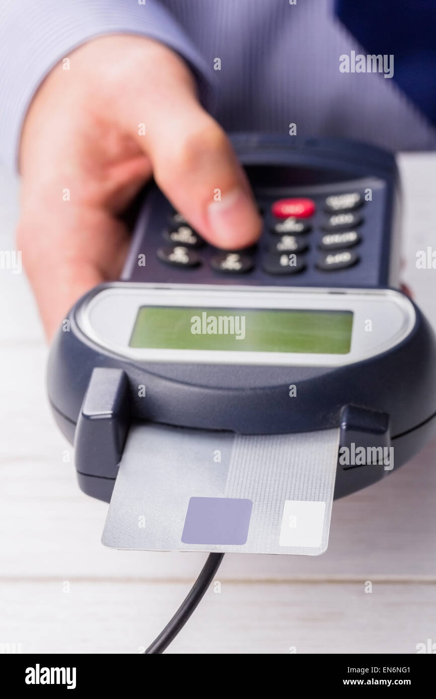 Man entering his pin on terminal Stock Photo - Alamy