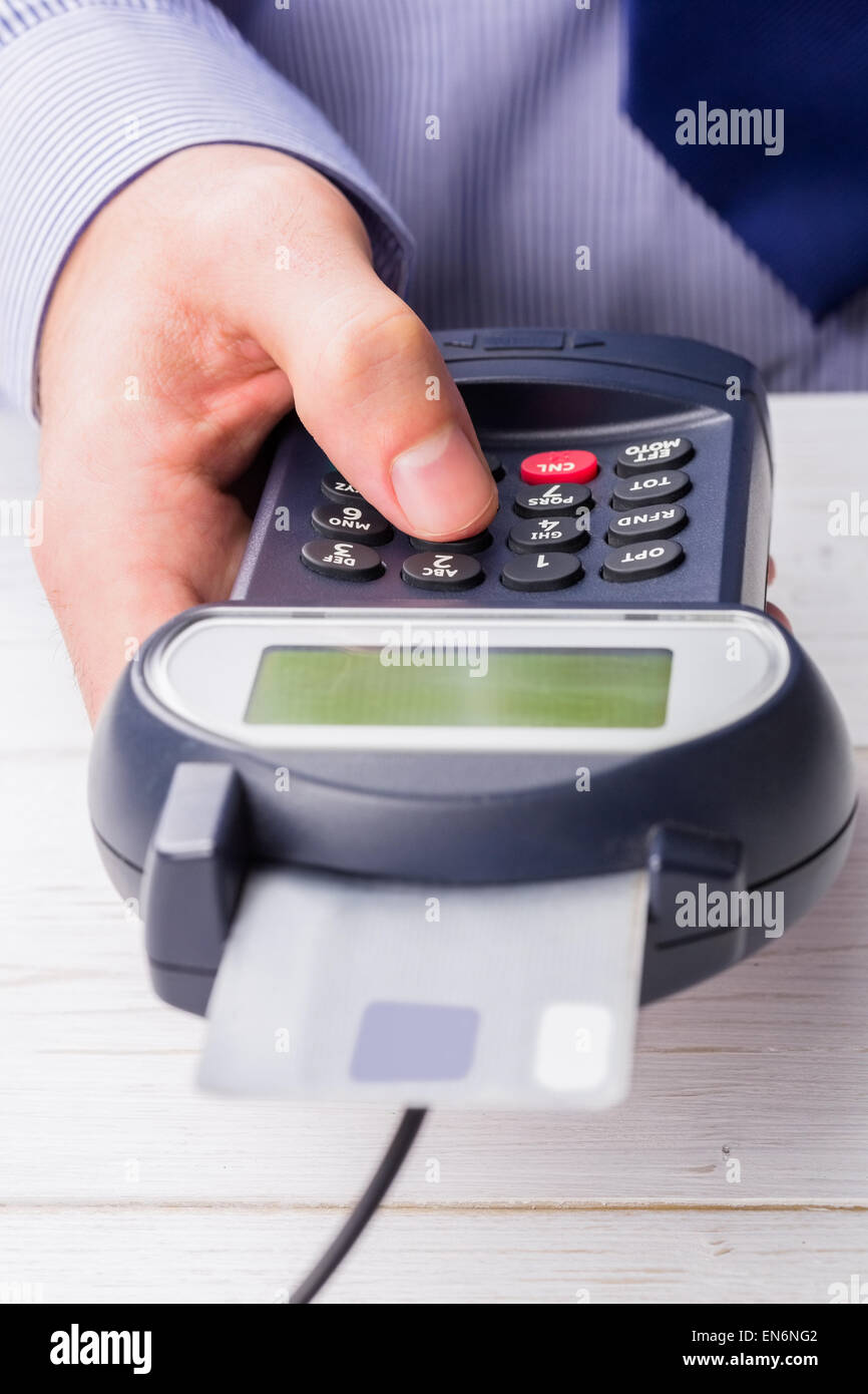 Man entering his pin on terminal Stock Photo - Alamy