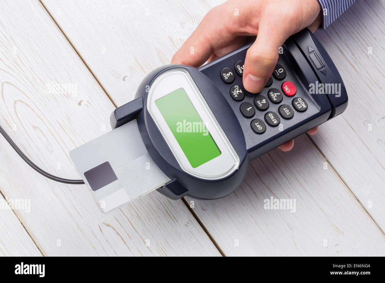 Man entering his pin on terminal Stock Photo - Alamy