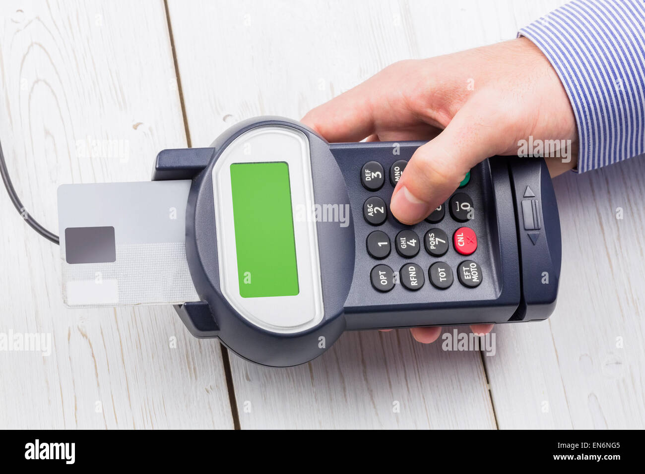 Man entering his pin on terminal Stock Photo - Alamy