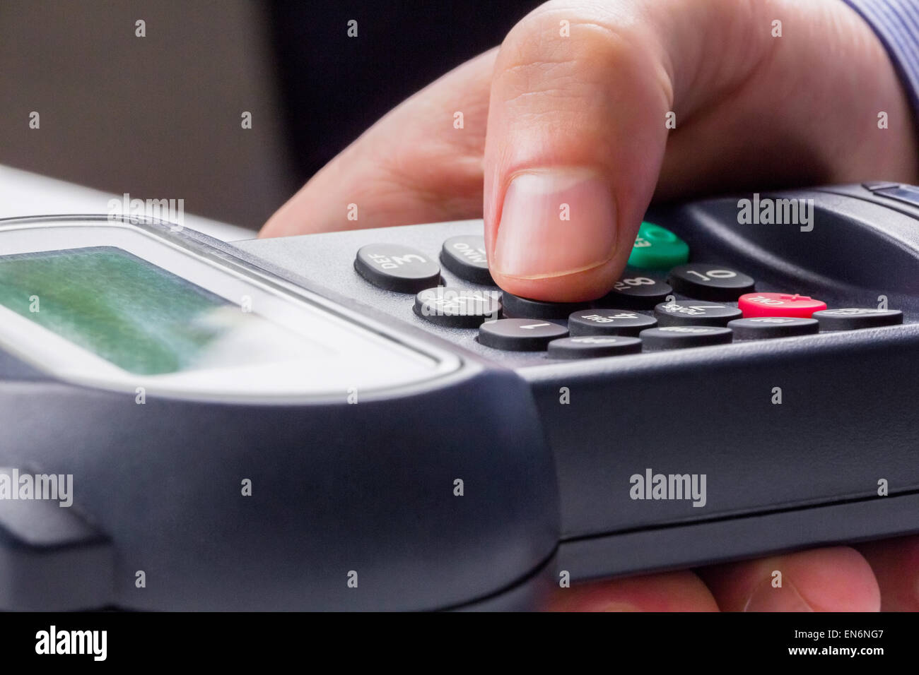 Man entering his pin on terminal Stock Photo - Alamy