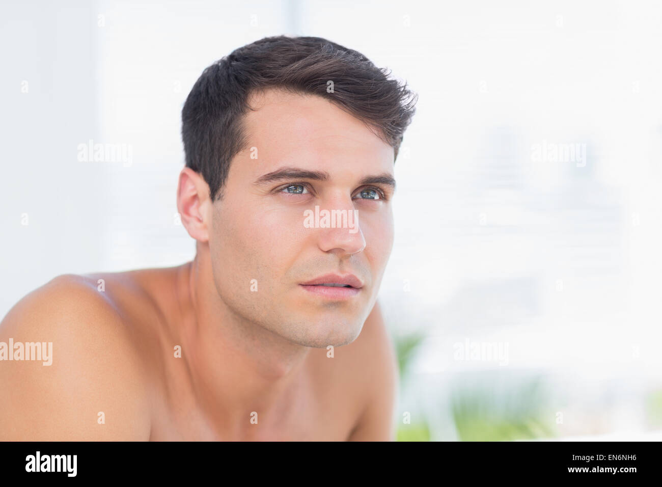 Thoughtful patient lying on massage table Stock Photo - Alamy