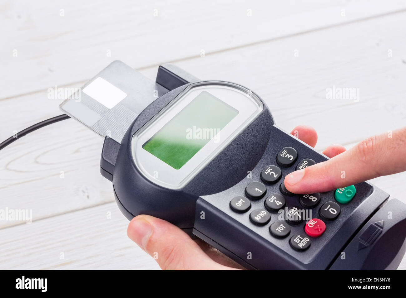 Man entering his pin on terminal Stock Photo - Alamy