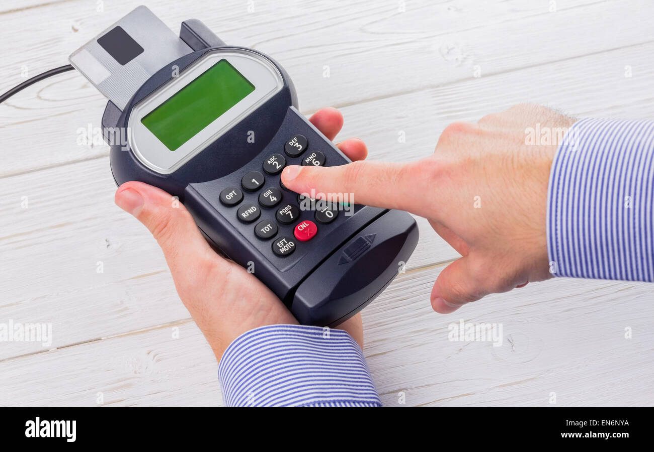 Man entering his pin on terminal Stock Photo - Alamy