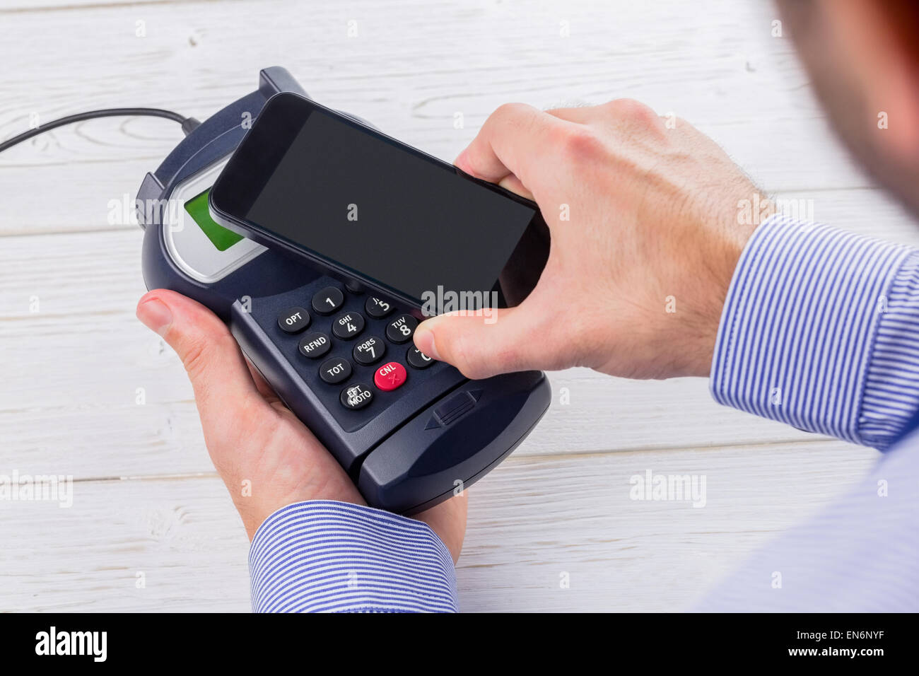 Man using smartphone to express pay Stock Photo - Alamy