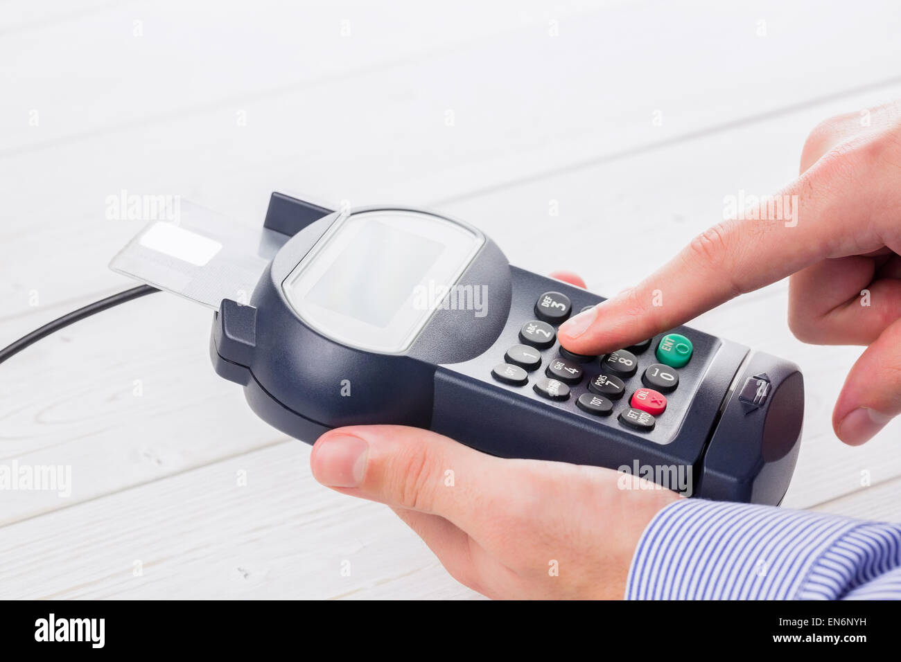 Man entering his pin on terminal Stock Photo - Alamy