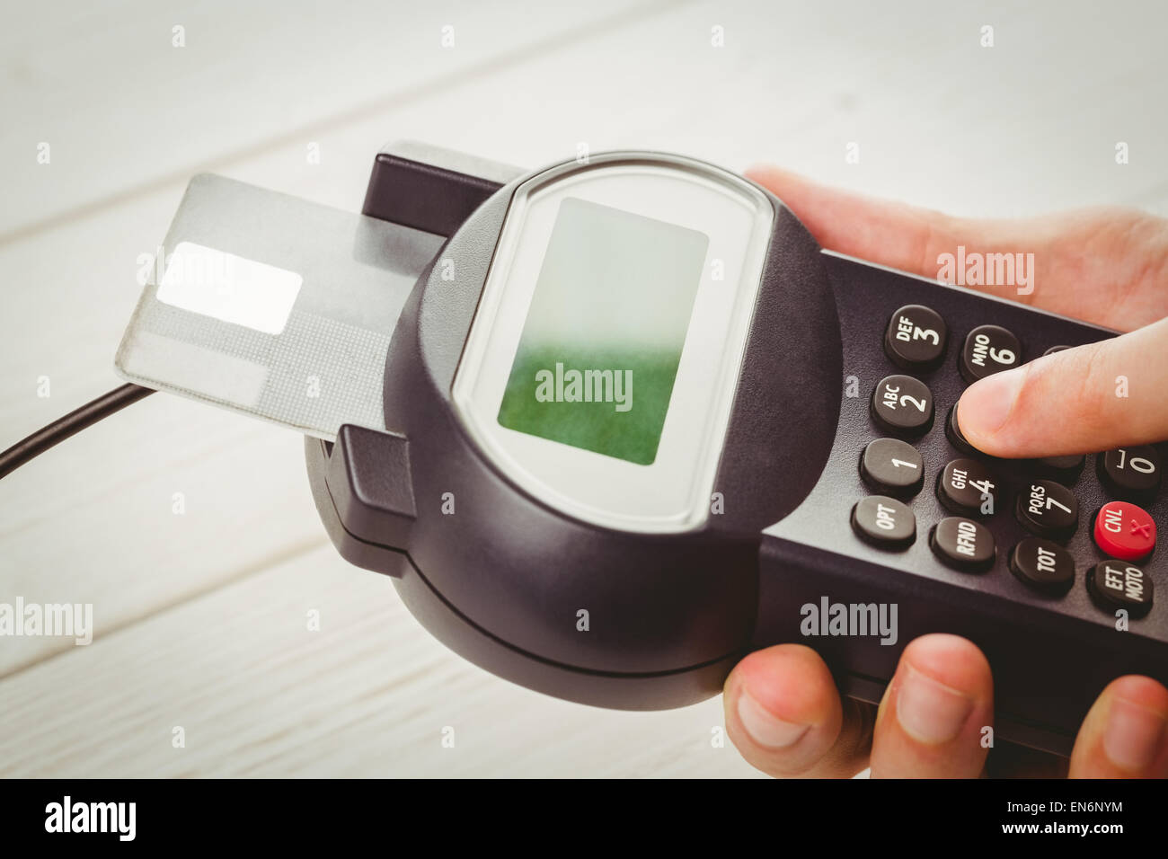 Man entering his pin on terminal Stock Photo - Alamy