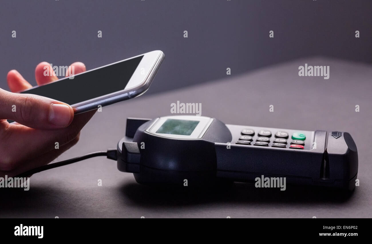 Man using smartphone to express pay Stock Photo - Alamy
