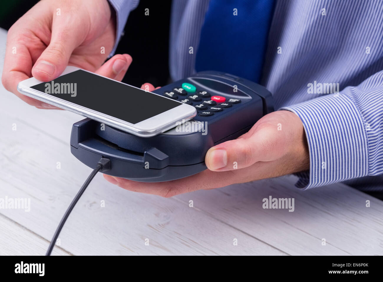Man using smartphone to express pay Stock Photo - Alamy