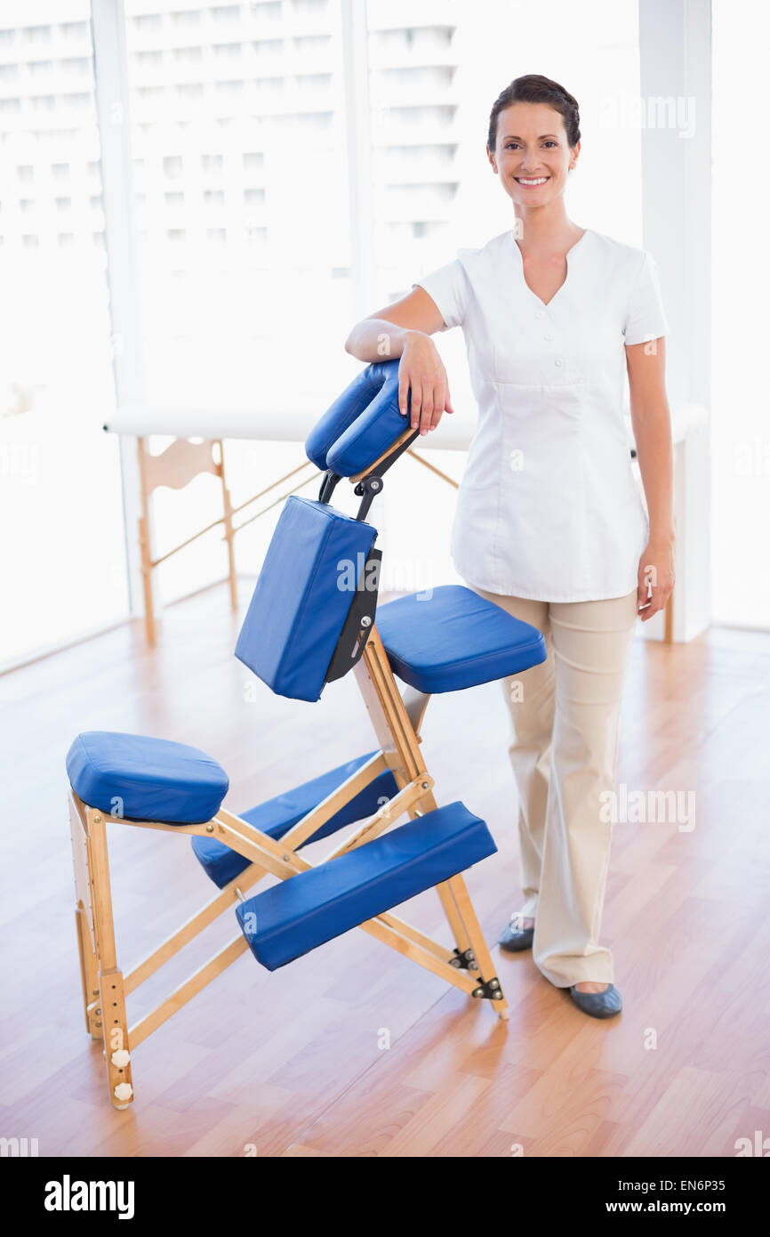 Smiling therapist standing massage chair hi-res stock photography and ...