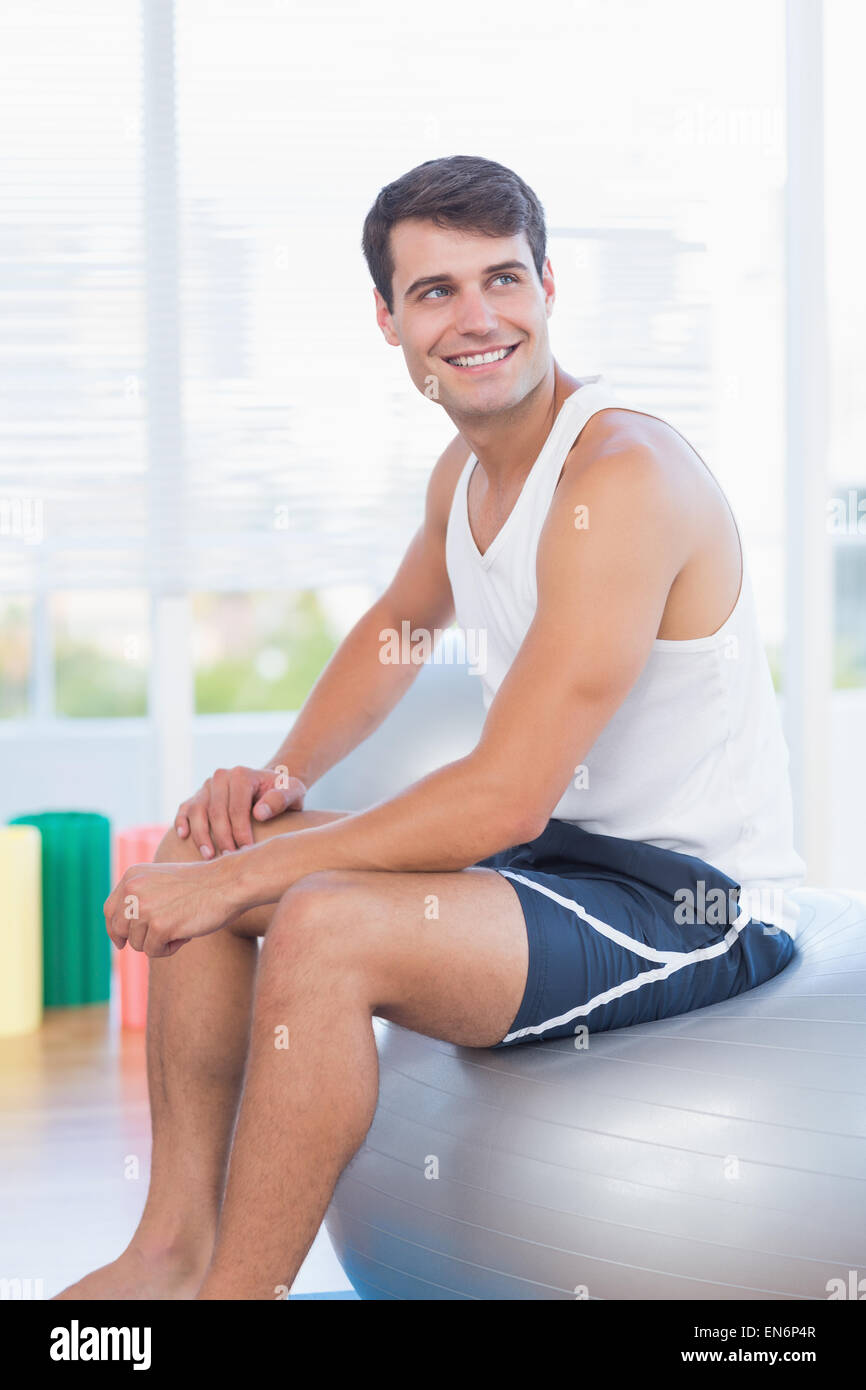 Man fit ball sitting hi-res stock photography and images - Alamy