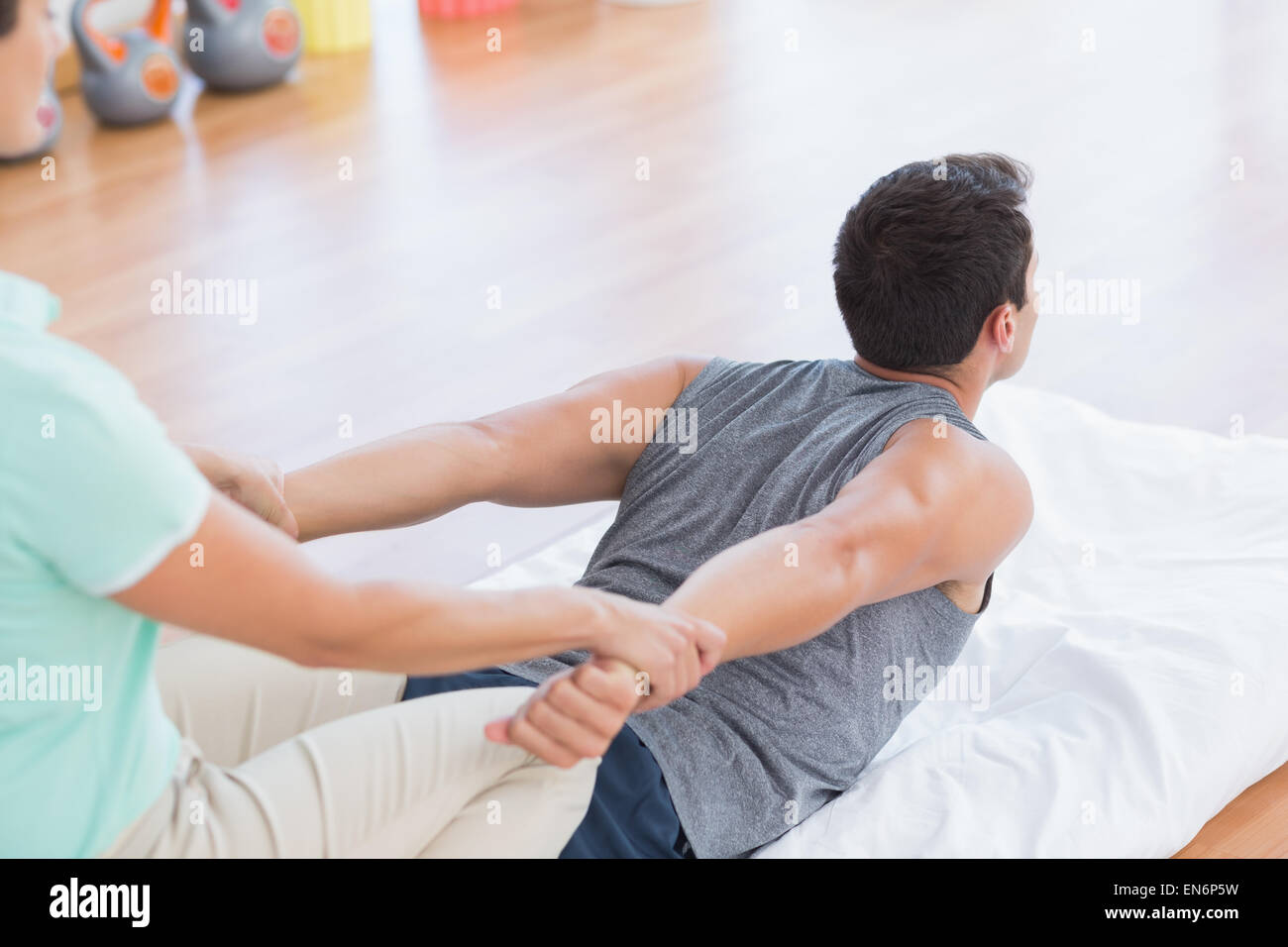 Man stretching with his trainer Stock Photo - Alamy