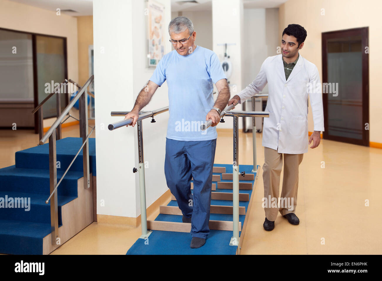 Physiotherapist helping patient to walk Stock Photo - Alamy