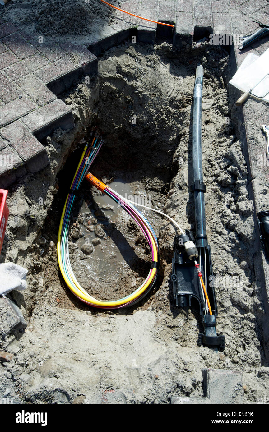Men laying optical fiber cables Stock Photo - Alamy