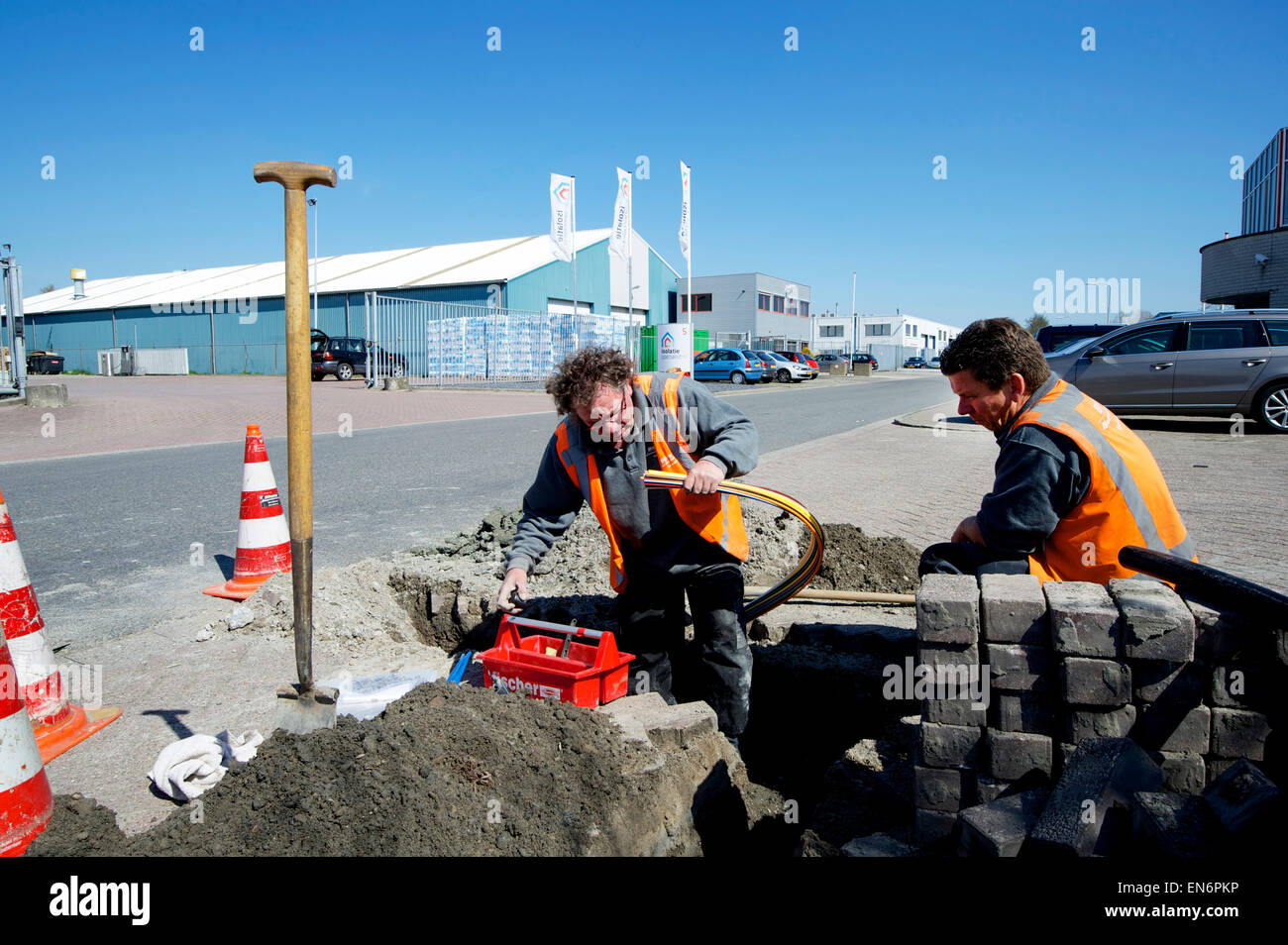 Men laying optical fiber cables Stock Photo - Alamy