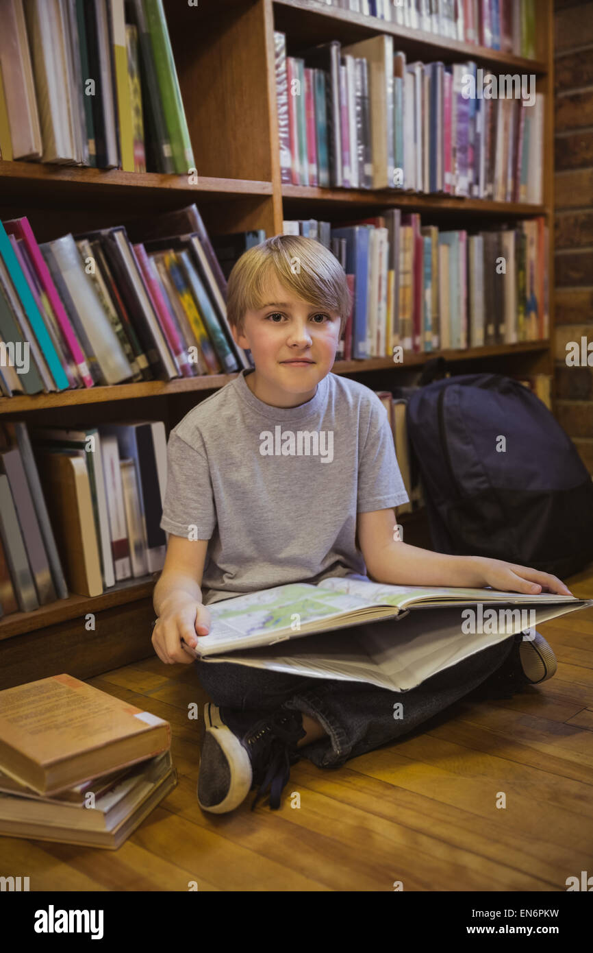 Little boy reading on library floor Stock Photo - Alamy