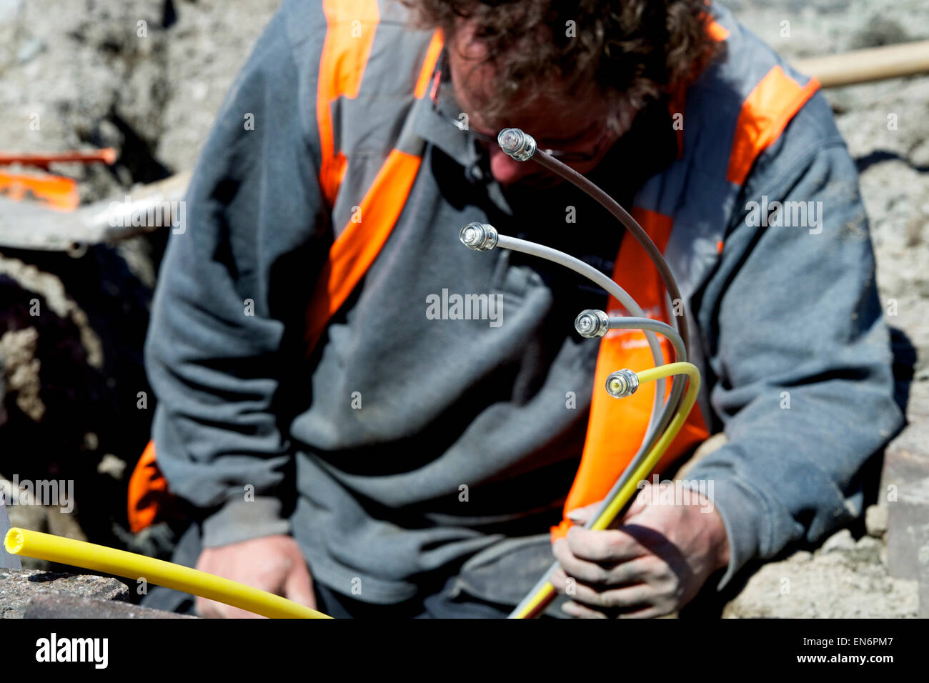 Men laying optical fiber cables Stock Photo - Alamy