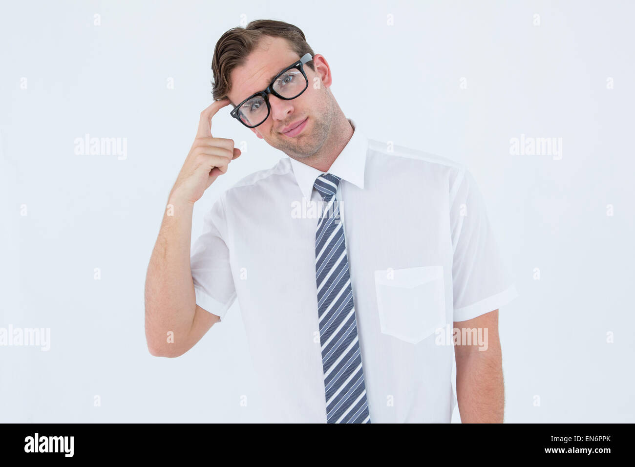 Geeky businessman thinking with finger on temple Stock Photo - Alamy
