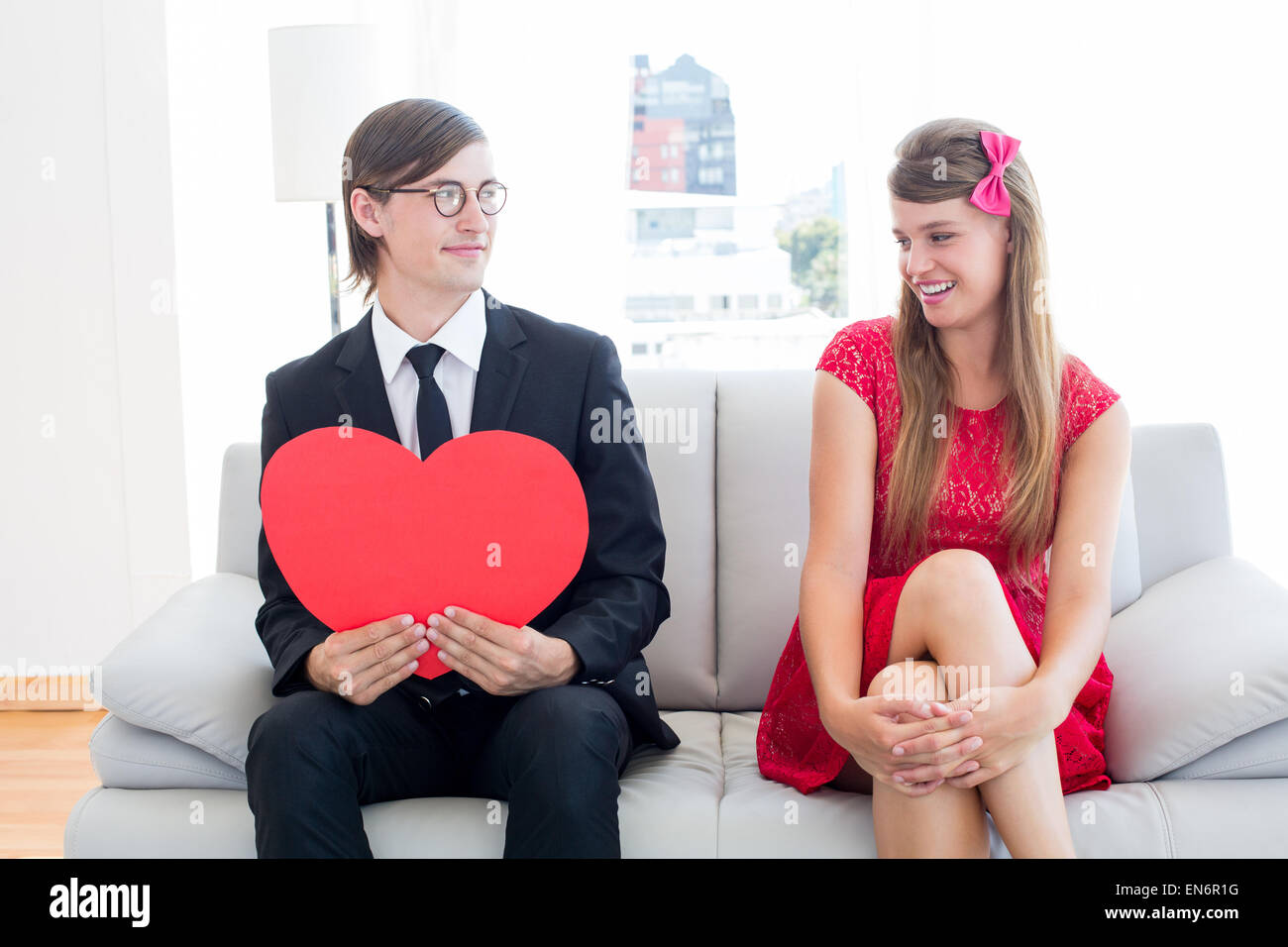 Cute geeky couple with red heart shape Stock Photo - Alamy