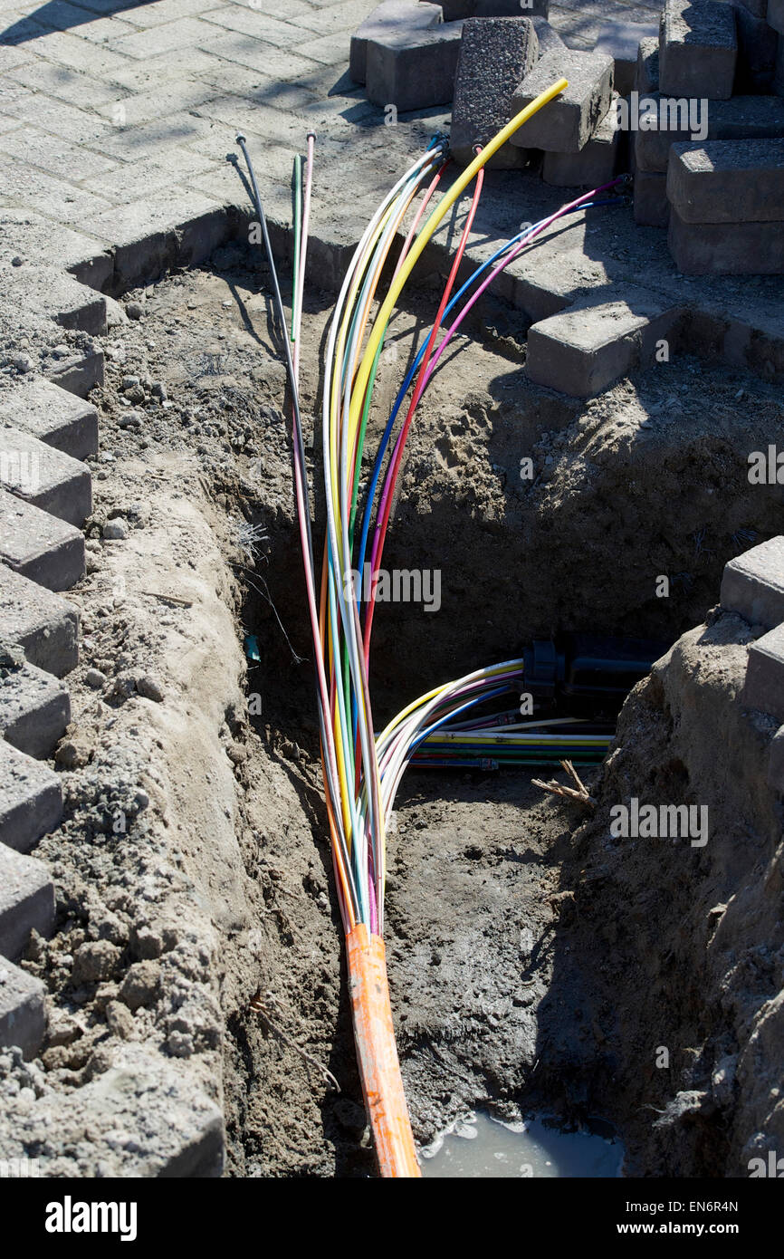 Men laying optical fiber cables Stock Photo - Alamy